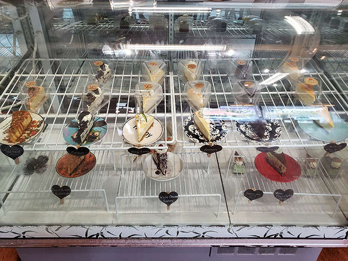 The display case showcases individual slices like jewels in a treasure chest, each one promising a unique adventure in flavor.