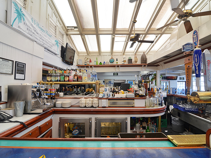 Behind this bar is where liquid happiness is crafted, with bottles standing at attention like sailors ready to serve.