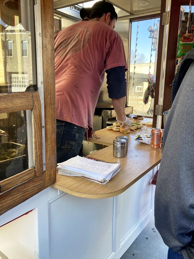 The serving window frames culinary theater where every performance ends with a standing ovation from stomachs.