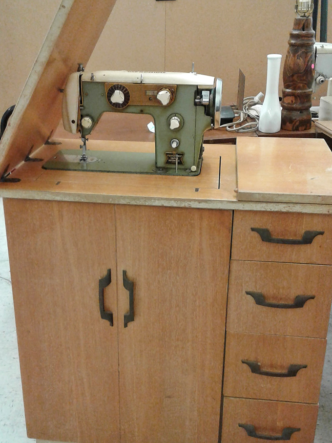 This vintage sewing machine in its original cabinet isn't just a tool—it's a time machine to when "homemade" was the highest compliment.