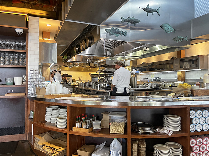 In this open kitchen, metal fish sculptures swim above chefs orchestrating a symphony of seafood. Dinner and a show, all in one.