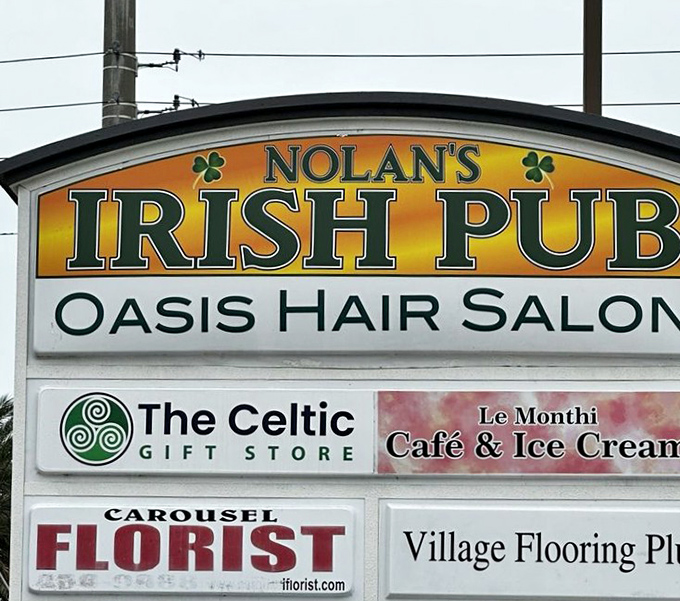 The neighborhood sign reveals Nolan's Irish Pub shares space with unlikely neighbors&mdash;proof that in Florida, hair salons and Celtic gifts coexist in perfect harmony.