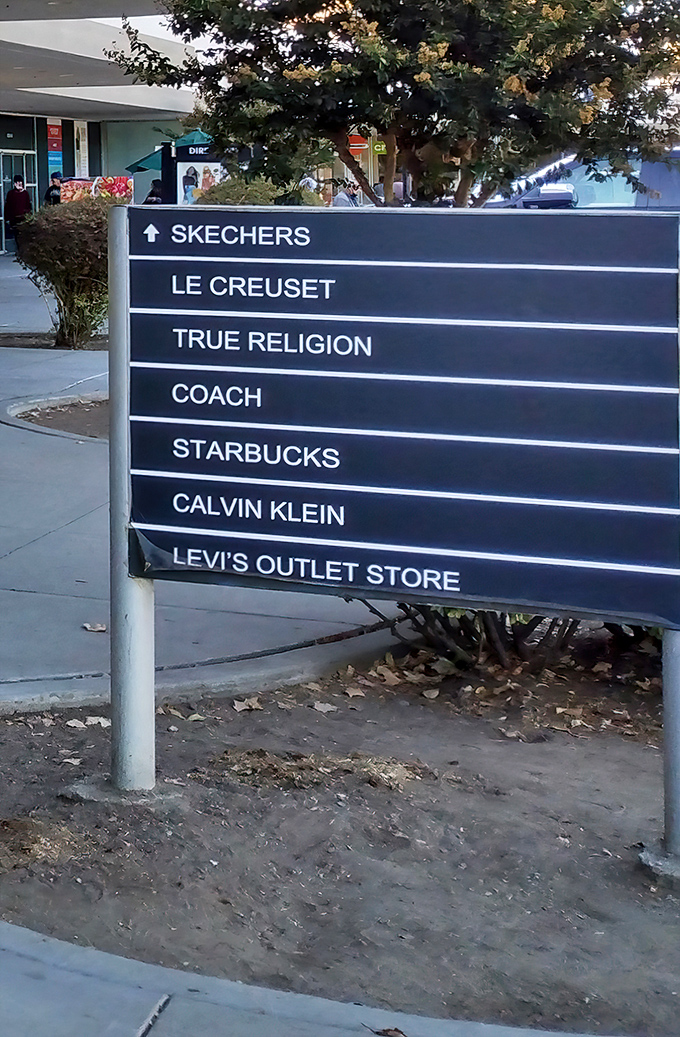 The signpost of savings points the way to retail nirvana. Follow the arrows to fashion enlightenment and wallet liberation.