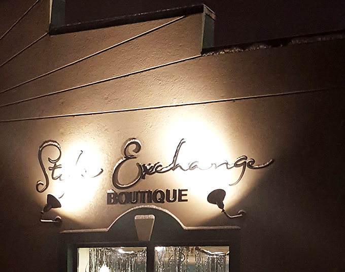 By night, the illuminated boutique sign becomes a beacon for fashion lovers seeking luxury without the luxury price tag.