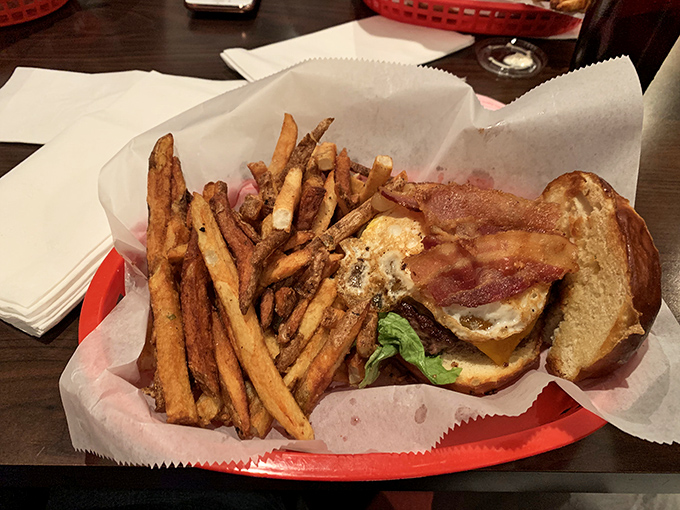 This smash burger with bacon and hand-cut fries isn't just a meal &ndash; it's a religious experience on a red basket.