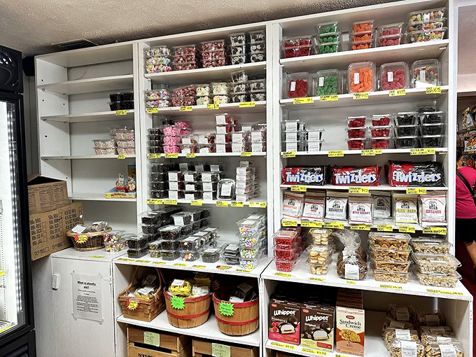 The candy and snack section proves that Amish Country Store understands comfort on every level. Those wooden barrels aren't just containers; they're time machines.