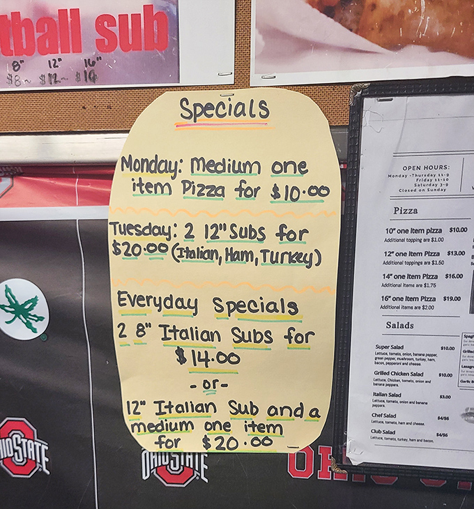 Hand-written specials board&mdash;where budget-friendly meets mouth-watering. Tuesday's two-sub deal might be the best thing since sliced bread.