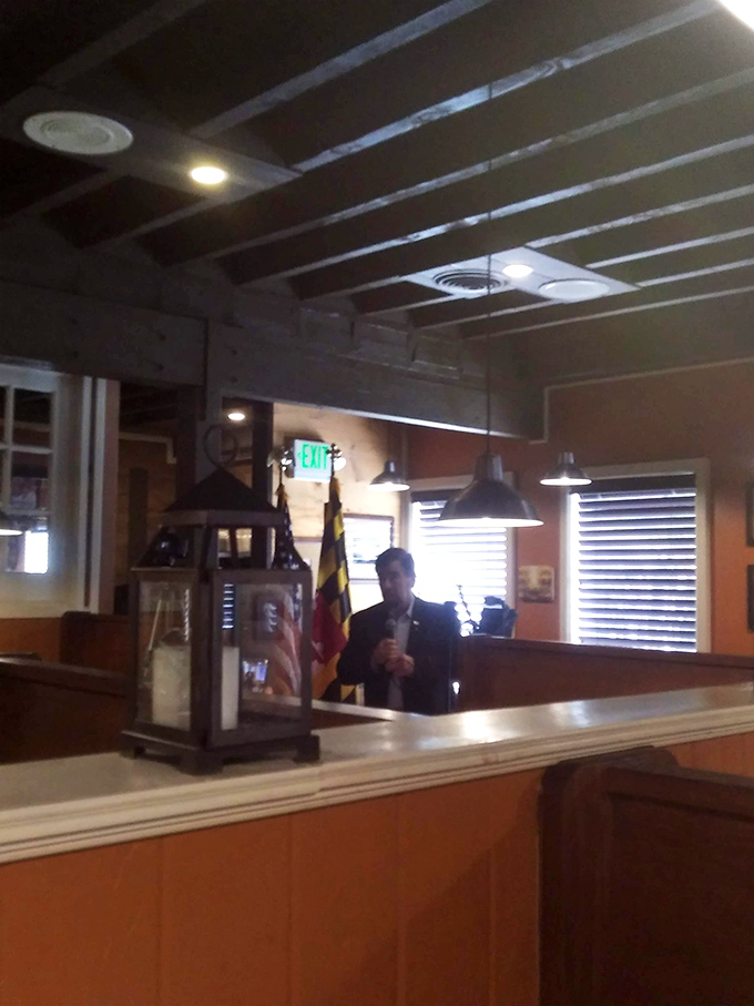 The host stand, complete with Maryland flag, reminds you that state pride and hospitality go hand-in-hand at this beloved establishment.