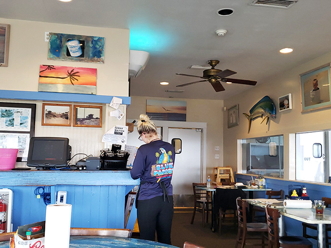 Behind every great beach meal is someone in a Blue Parrot shirt making the magic happen. The ceiling fan keeps the vibe as cool as the service.