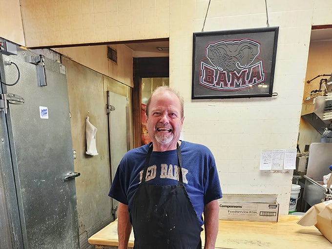 The smile of someone who knows his smoke ring is perfect. BBQ isn't just food here&mdash;it's a calling.