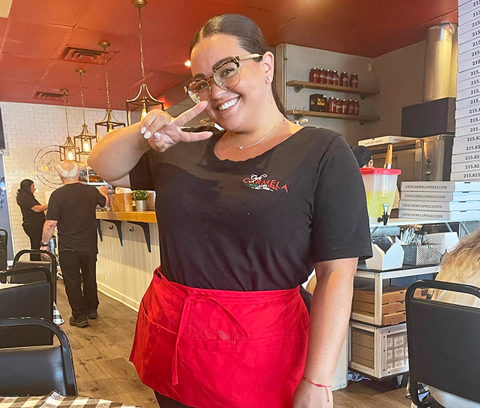 Service with a genuine smile—the secret ingredient that turns a good meal into a great one. Her apron says business, her expression says welcome.