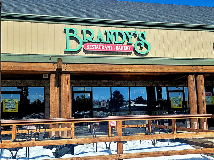 The sign beckons like a lighthouse for the hungry. In winter, that snow-dusted deck transforms into a magical breakfast wonderland.