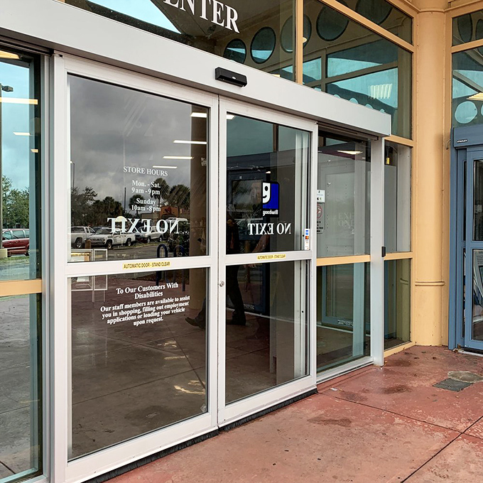 The gateway to greatness—store hours posted on doors that thousands pass through daily in search of that perfect something at the perfect price.