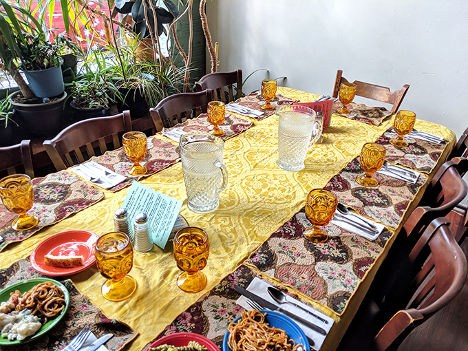Amber glassware catches light like liquid sunshine on this meticulously set table. Dining here feels like being invited to a fabulous friend's dinner party.