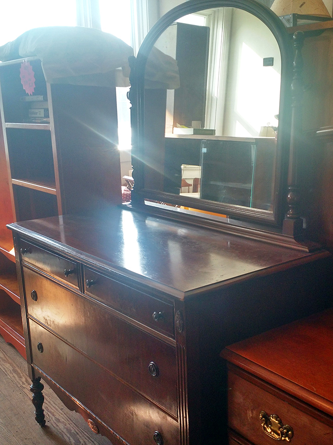 This stately dresser with mirror has witnessed decades of morning routines and "Does this look okay?" moments, ready to bring vintage elegance to contemporary bedrooms.