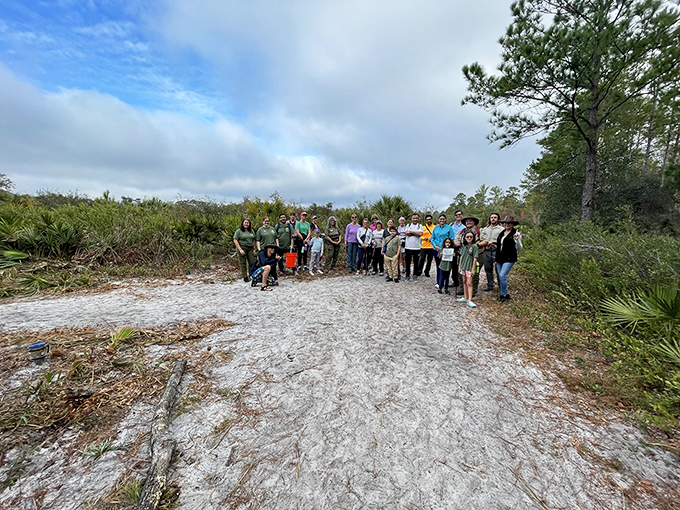 Explorers gather on Wekiwa's rare white sand scrub – a specialized ecosystem that's as close as Florida gets to having its own mini-desert.