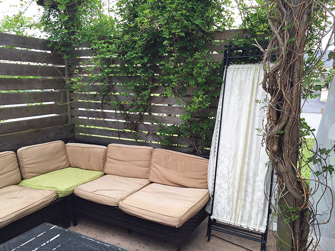 The outdoor lounge area &ndash; where ivy-covered privacy meets comfortable seating, perfect for sipping a pint on Indiana's gentler summer evenings.