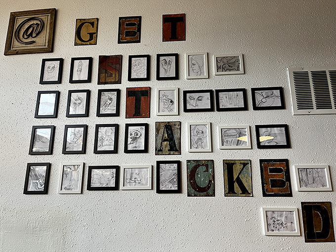 Wall art that spells out "GET STACKED" surrounded by sketches&mdash;because great food deserves its own gallery exhibition.