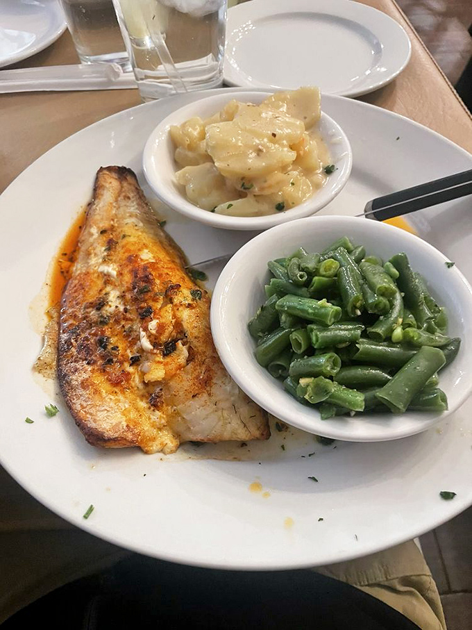 Fish that would make Lake Erie proud—perfectly seared walleye accompanied by green beans and mac and cheese that refuse to be overshadowed.