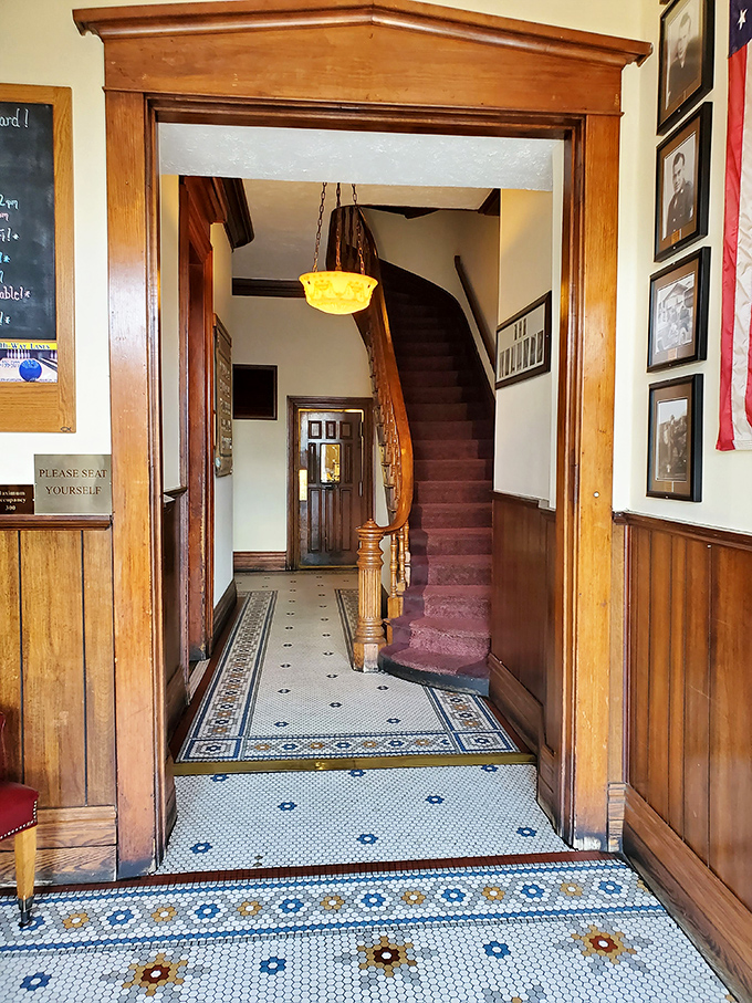 The entryway's vintage tile floor and wooden staircase whisper stories of generations who've walked this path toward deliciousness. History you can step on.