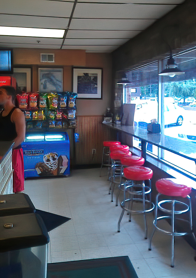 Window seats with cherry-red stools offer prime people-watching real estate while you wait for your pizza masterpiece to emerge from the oven.