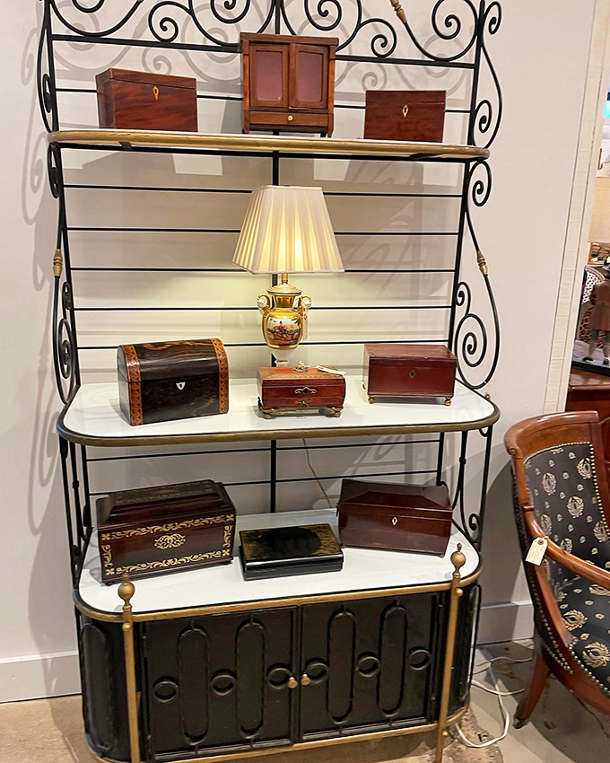 Not just boxes, but tiny time capsules of craftsmanship displayed on shelves that showcase their intricate details and warm patinas.