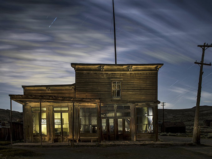 Bodie's ghostly general store glows with ethereal light, frozen in time like a sepia-toned photograph.