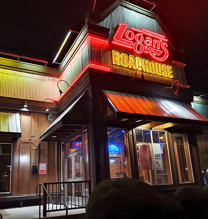 Logan's neon-lit exterior glows with roadhouse promise - where hand-cut steaks and down-home atmosphere create unforgettable dining memories.