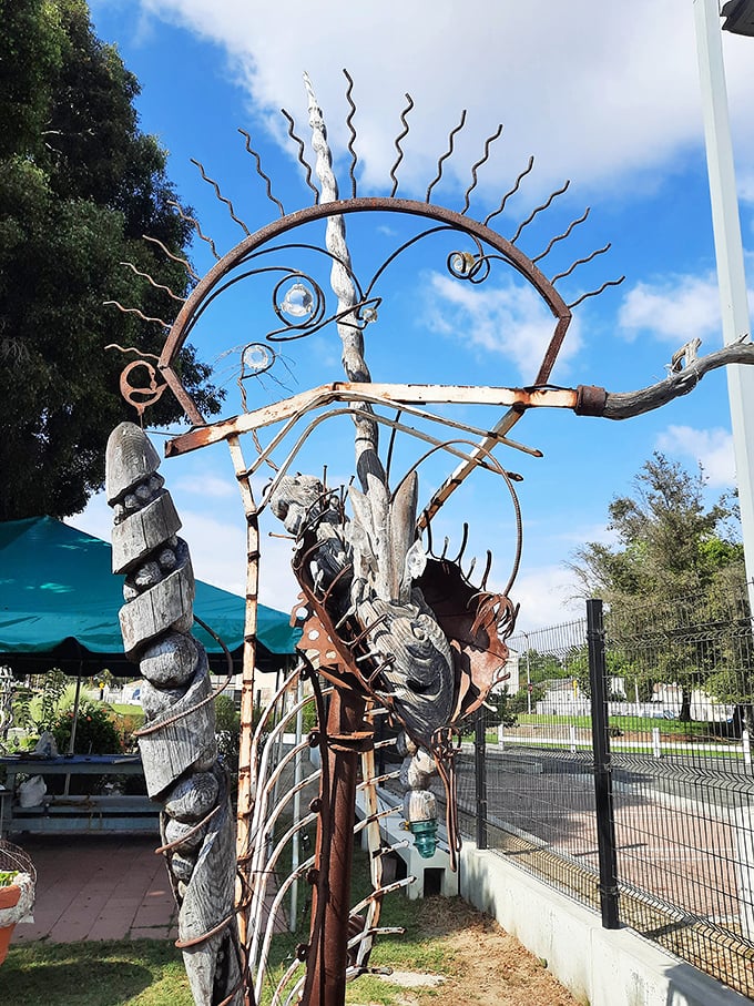 Sunburst archways and found-object sculptures extend the artistic vision beyond the towers themselves, creating unexpected moments of wonder.