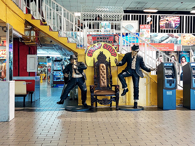Life-sized statues guard ATMs like friendly bouncers, adding whimsy to mundane banking transactions at markets.