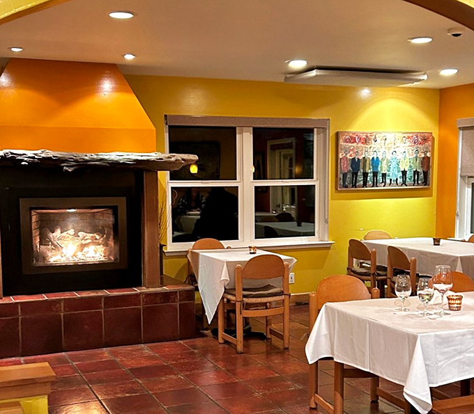 The fireplace corner might be the most coveted spot in winter, where the crackling fire competes with the sizzle from the kitchen.