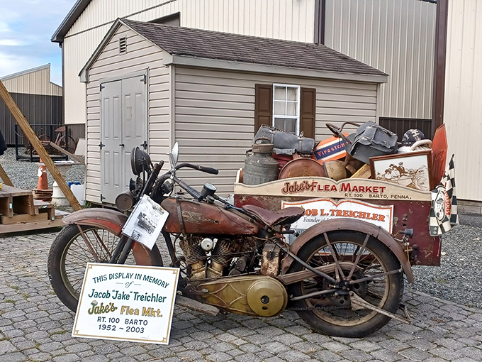 A rusted motorcycle with sidecar stands as a memorial to Jake Treichler, whose vision created this treasure-hunting paradise.