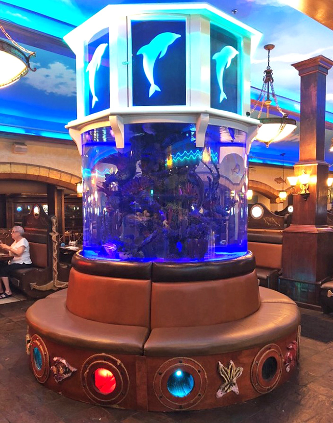 The centerpiece aquarium brings the ocean to your table, with illuminated dolphins watching over diners like benevolent sea guardians.