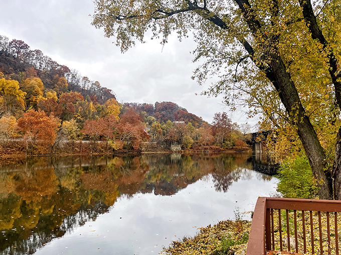 Fall foliage reflected in still waters creates nature's perfect mirror image&mdash;no filter needed, though thousands will be applied anyway.
