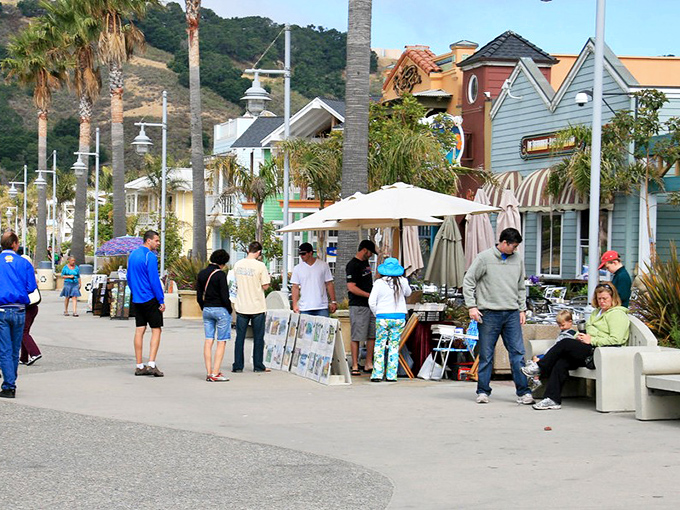 The promenade transforms into an open-air gallery where art mingles with ocean air, and browsers become buyers faster than you can say "beach house wall."