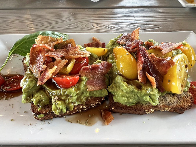 Avocado toast that's dressed for success&mdash;bacon confetti and colorful tomatoes transform this millennial clich&eacute; into something worth writing home about.