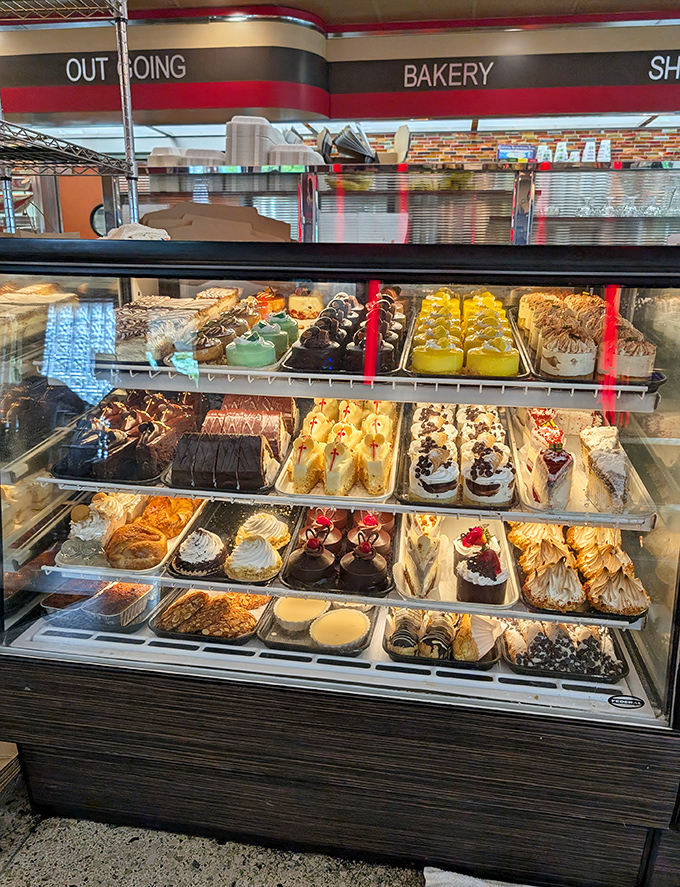 The dessert case: where willpower goes to die a glorious, sugar-coated death. Each shelf offers a different path to sweet satisfaction.