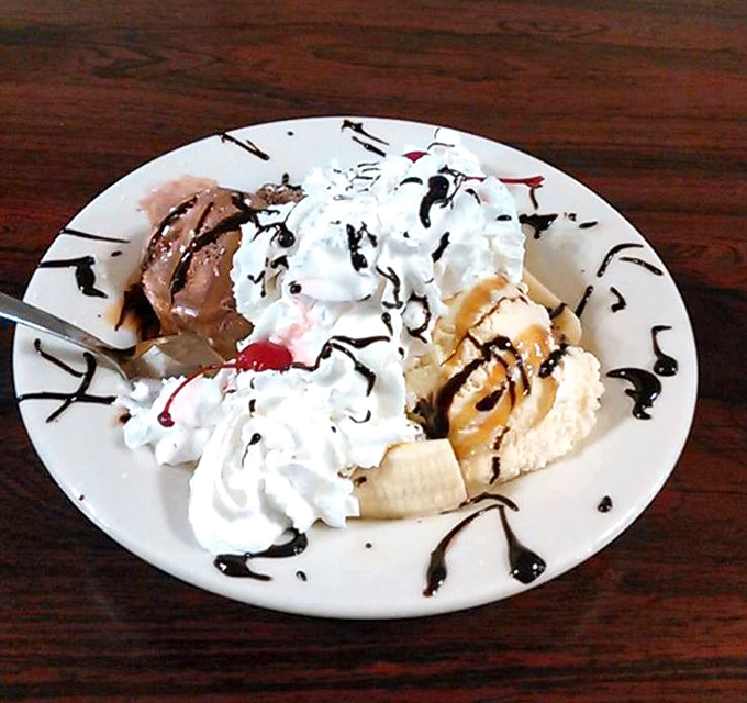 A banana split that defies modern portion control. Whipped cream, chocolate sauce, and multiple ice cream flavors create a dessert worth every calorie.