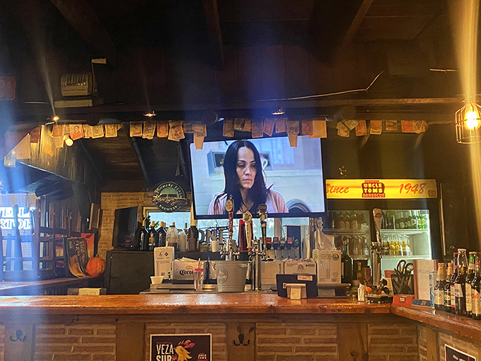 The bar area serves as command central for this barbecue operation, where cold drinks flow as freely as the conversations between strangers-turned-friends.