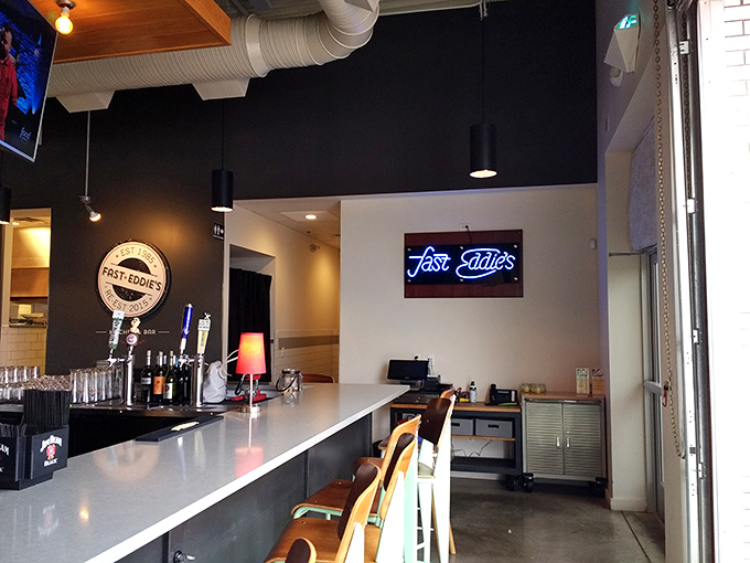 The bar seating offers front-row tickets to the liquid artistry happening behind the counter, with that neon sign promising good times ahead.