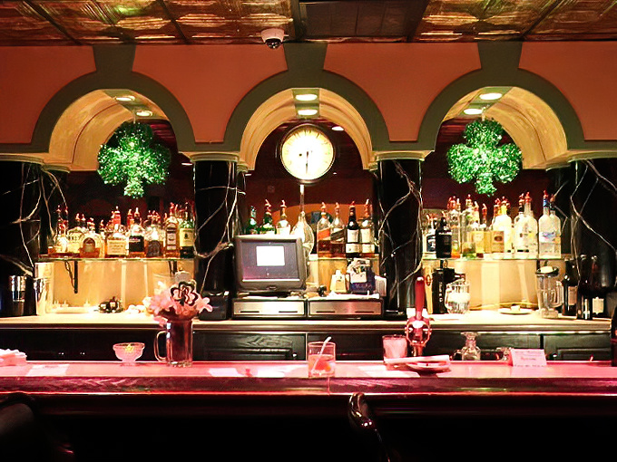 The bar's arched alcoves showcase bottles like museum pieces, while the warm glow promises cocktails mixed with both skill and generosity.