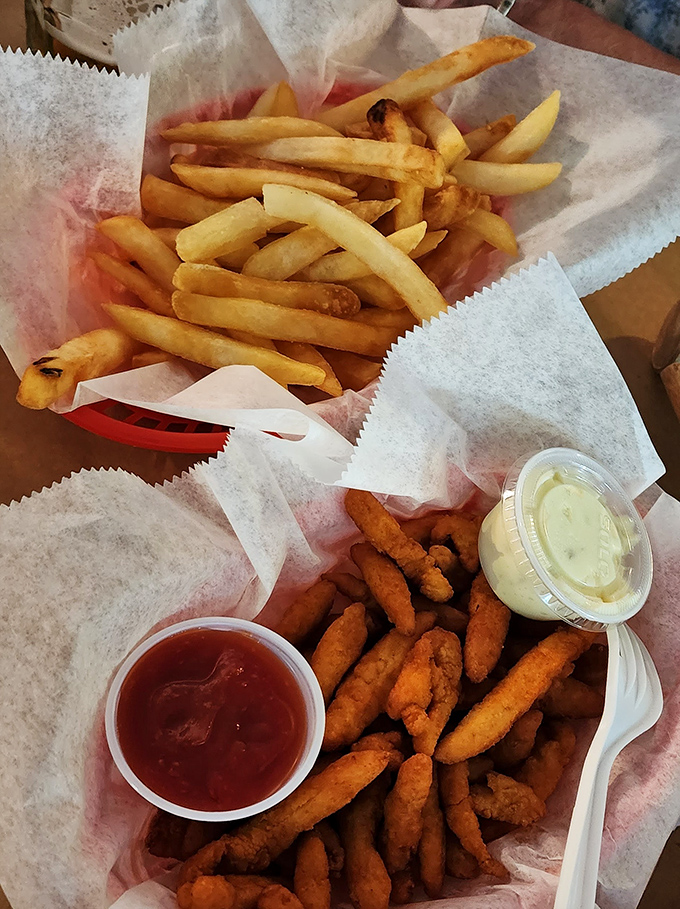 Golden fries and crispy seafood bites served in paper baskets&mdash;the universal language of coastal comfort food done right.