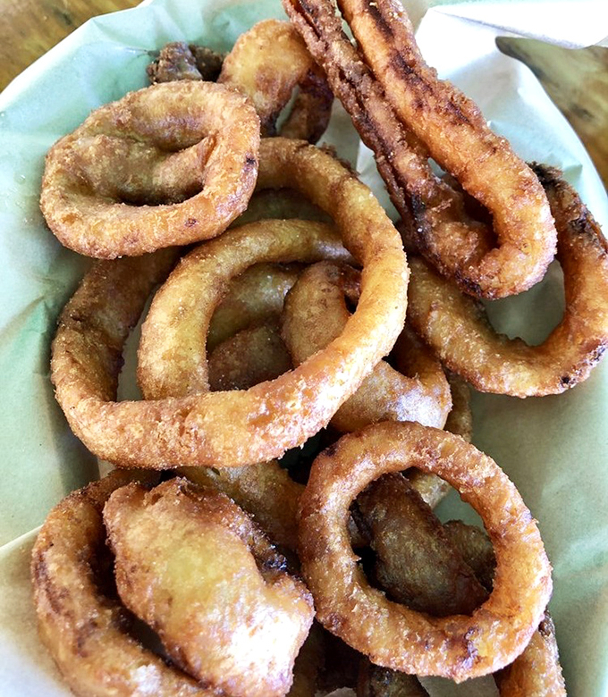 These onion rings aren't just side dishes&mdash;they're golden halos of crispy perfection that deserve their own moment of reverence.