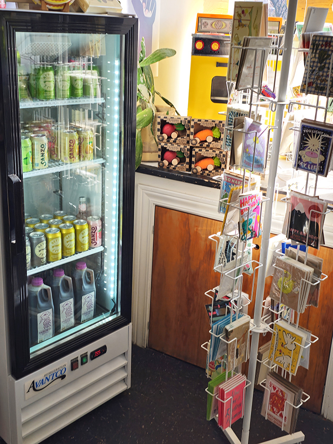 A refrigerator stocked with colorful beverages and a rack of charming cards. Hydration and good wishes&mdash;they've thought of everything.