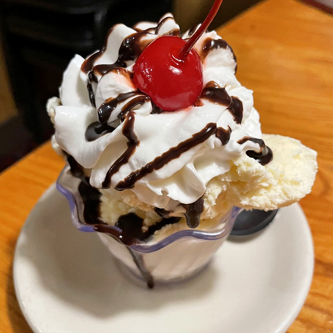 Ice cream architecture at its finest, with that cherry standing guard like a tiny, delicious sentinel. Worth celebrating even when it's not your birthday.