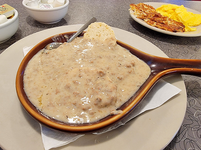 Biscuits drowning in creamy sausage gravy represent everything wonderful about Southern comfort food done absolutely right here.