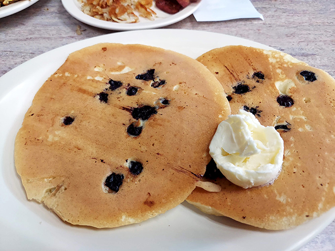 Blueberry pancakes that make you question why you ever eat anything else. That dollop of butter slowly melting is nature's perfect timer.