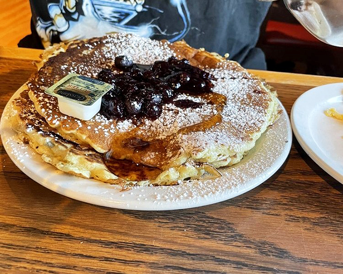 These blueberry pancakes dusted with powdered sugar aren't just breakfast—they're the reason alarm clocks were invented in the first place.