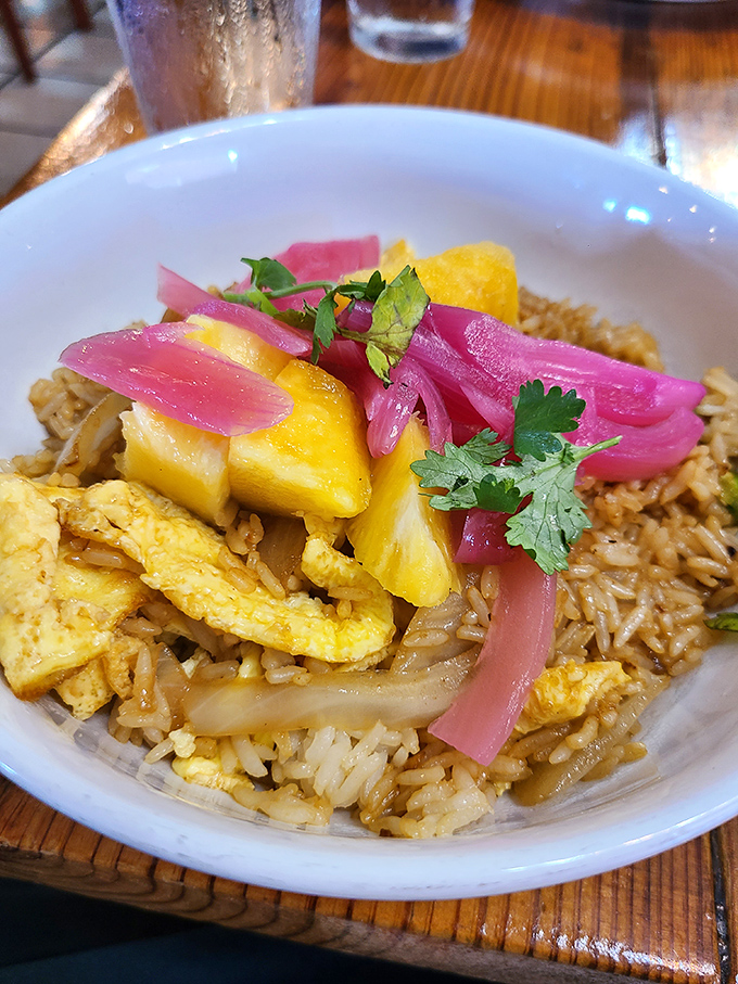 Not your average breakfast bowl &ndash; this vibrant creation with pickled onions and fresh herbs proves rice belongs at the morning table.