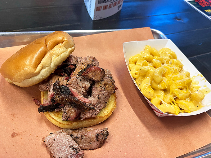 A brisket sandwich that requires both hands and your full attention, with mac and cheese that refuses to be a mere sidekick.